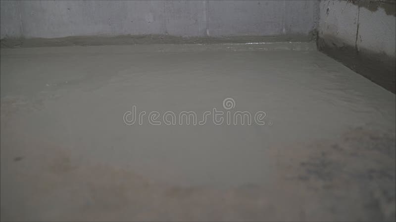 A Worker is Waterproofing a Concrete Floor. Construction Mix ...