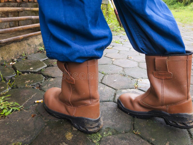 Worker Boots on Stone Path stock image. Image of leather - 360283053