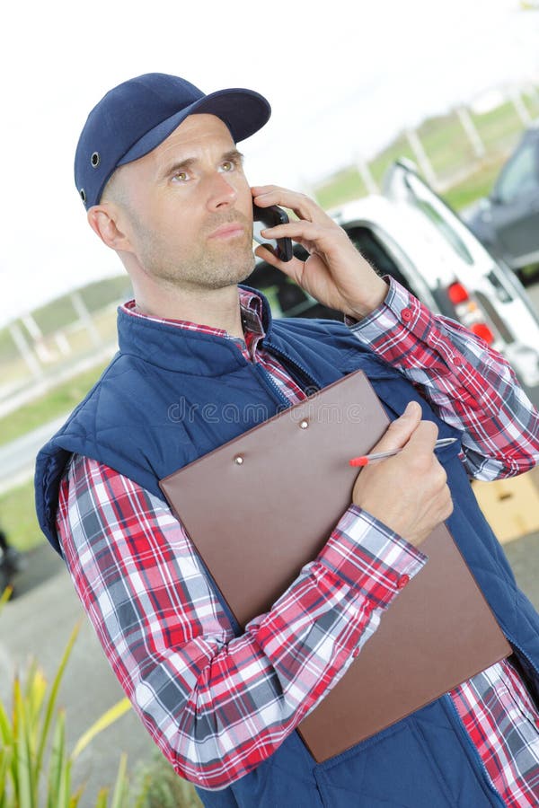 Worker Wearing Cap Using Mobile Phone in Warehouse Stock Image - Image ...