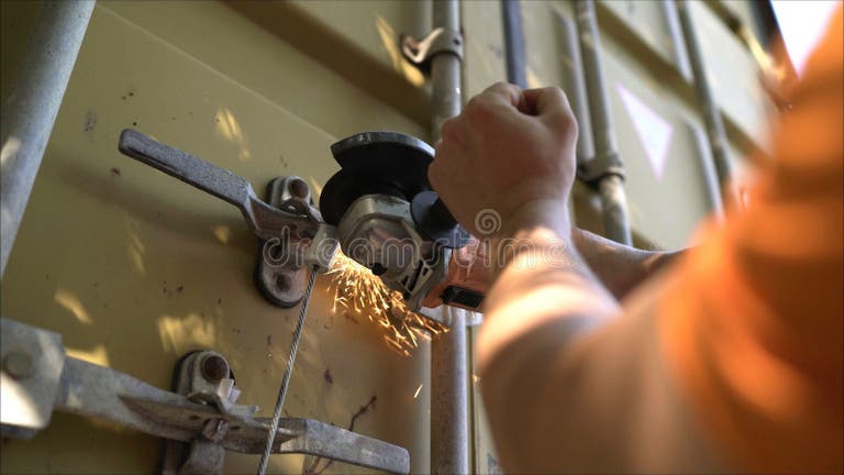 Worker Using Angle Grinder Cutting Metal Lock on Shipping Container ...