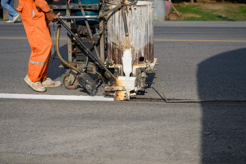 Worker Wearing Uniform is Making the White Line on Road with Painting ...