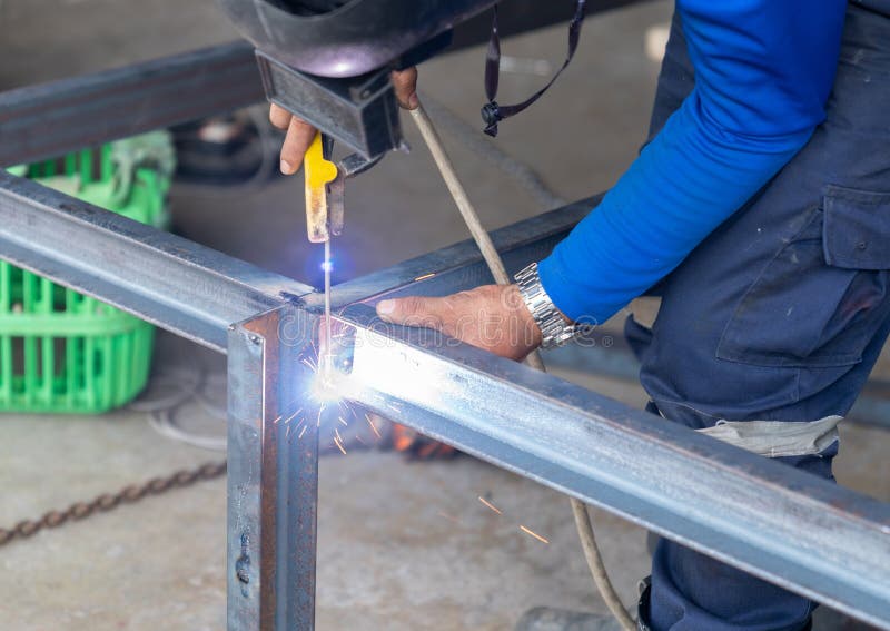 Worker Welding Leg of Table with His Hands, Sparks without Gloves Stock ...