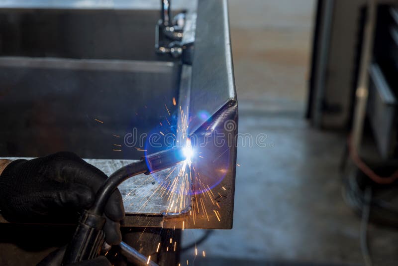 The Worker is Welding a Metal with Sparkle Using a Semi-automatic Argon ...
