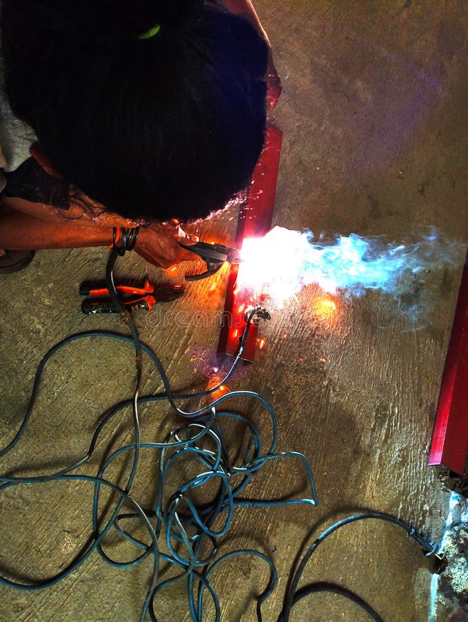 A Worker is Welding, Producing a Bright Light Stock Photo - Image of ...