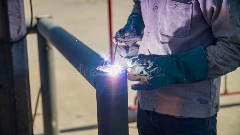 Worker is Welding Steel Frame Construction at Site. Stock Photo - Image ...