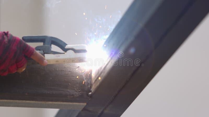 Worker Welding Two Pieces of Rectangular Tubing Together for Structure ...