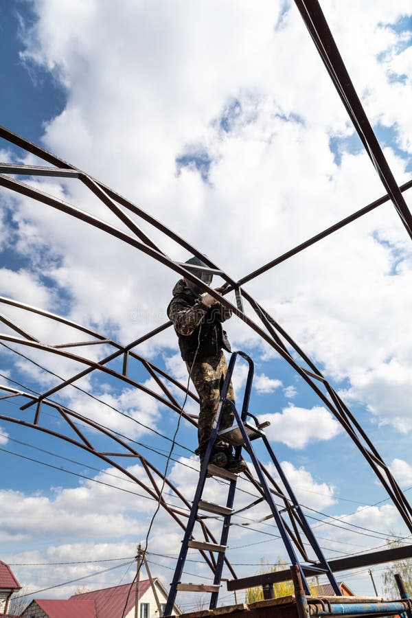 A Worker Welds Metal To the Canopy. Technologies Stock Photo - Image of ...