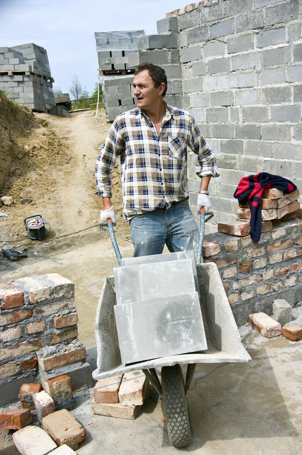 Worker with wheelbarrow stock photo. Image of construction - 5464404