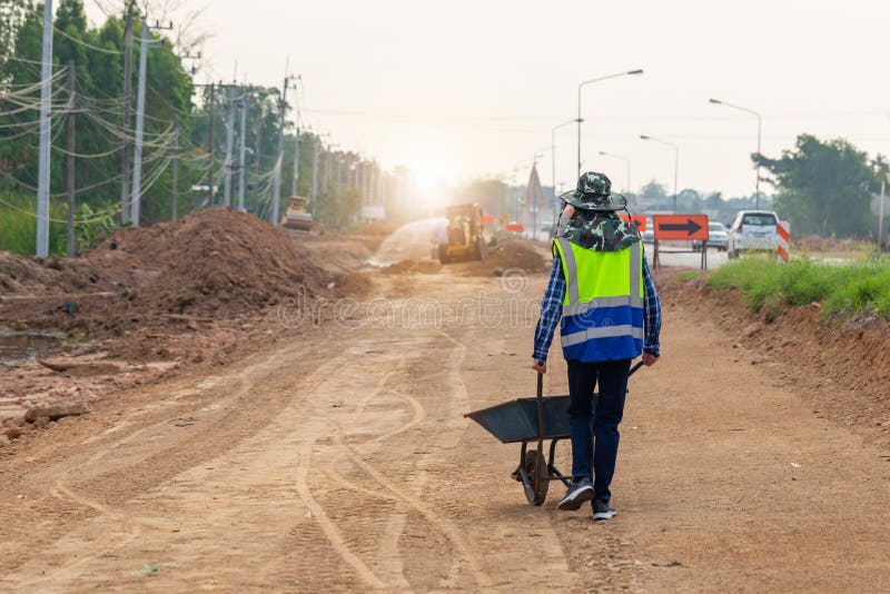 Worker with Wheelbarrow at Road Construction Site Stock Image - Image ...