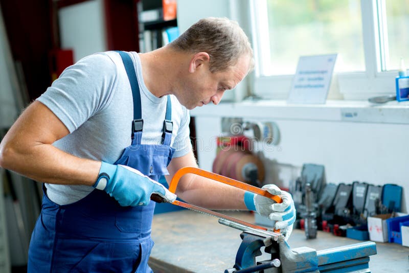 Worker on Work Bench in Factory Stock Photo - Image of earmuffs, metal ...