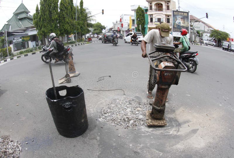 Patching the Road. Workers in Uniform Lay Asphalt from a Truck ...