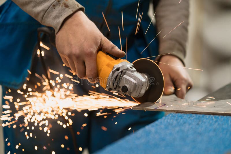Worker Working with a Circular Grinder on a Metal with Sparks Stock ...