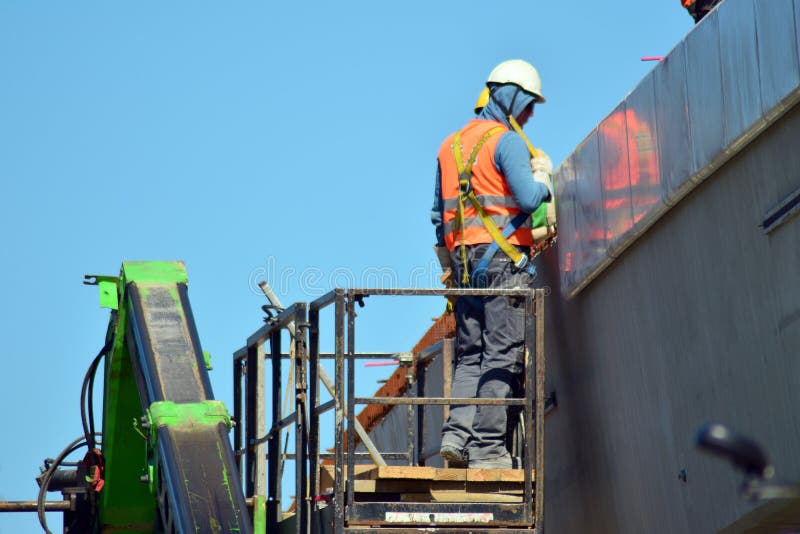 Construction Workers on a Scaffold. Stock Photo - Image of light ...