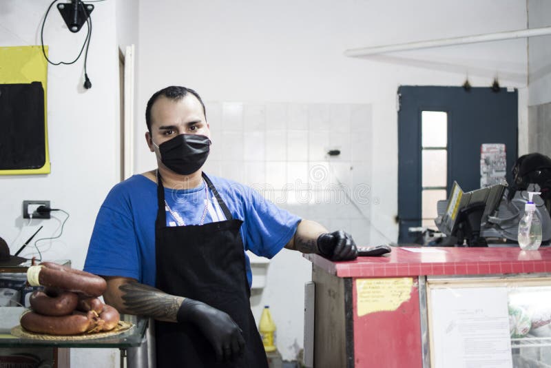 Worker Working in a Deli, Wearing a Black Apron Stock Image - Image of ...