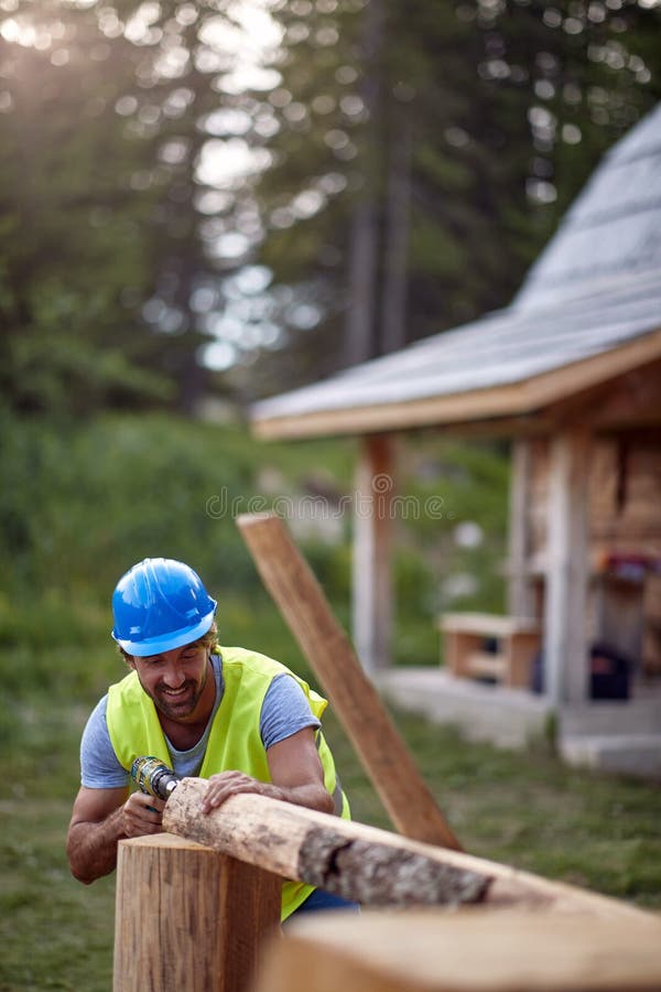 Worker Working with Drilling Machine on Wooden Construction. Carpenter ...