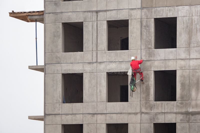 Worker Working on the Facade of the Building Stock Photo - Image of ...