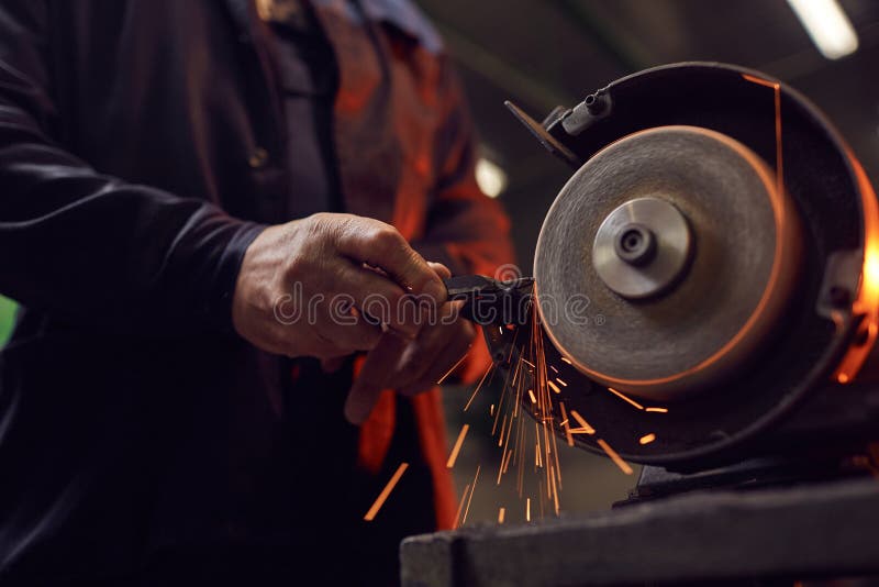 Worker working on grinder stock photo. Image of sparks - 166370326