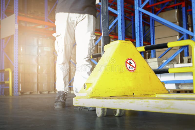 Worker Working with Hand Pallet Jack Unloading Cargo Boxes at the ...