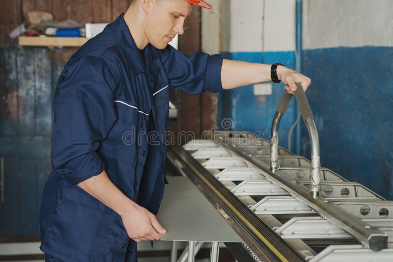 Worker Working on the Machine for Cutting Metal Sheets Stock Photo ...