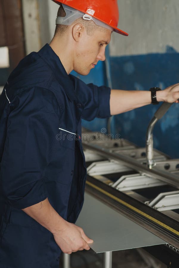 Worker Working on the Machine for Cutting Metal Sheets Stock Image ...