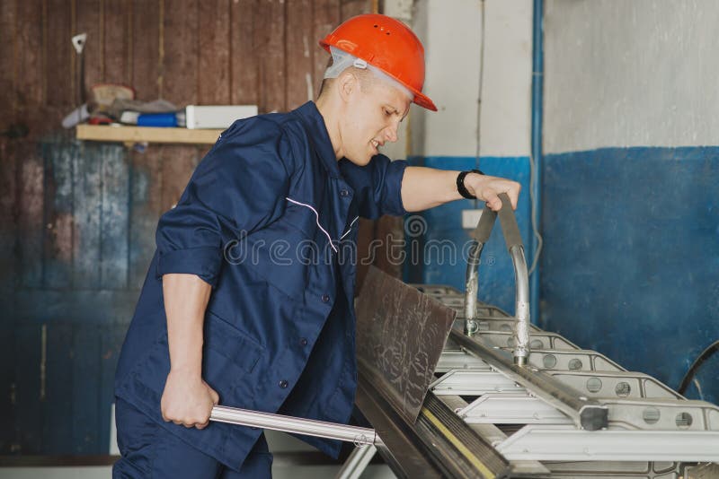 Worker Working on the Machine for Cutting Metal Sheets Stock Photo ...