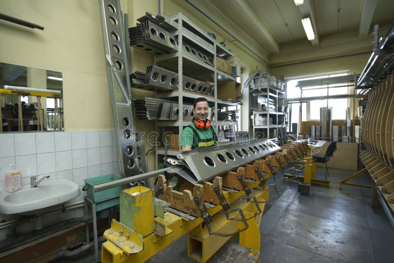 Worker Working with a Pneumatic Drill Assembling a Fuselage of Light ...