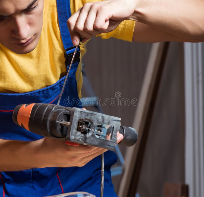 Worker Working in Repair Workshop in Woodworking Concept Stock Photo ...