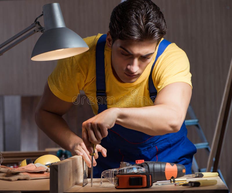 Worker Working in Repair Workshop in Woodworking Concept Stock Photo ...