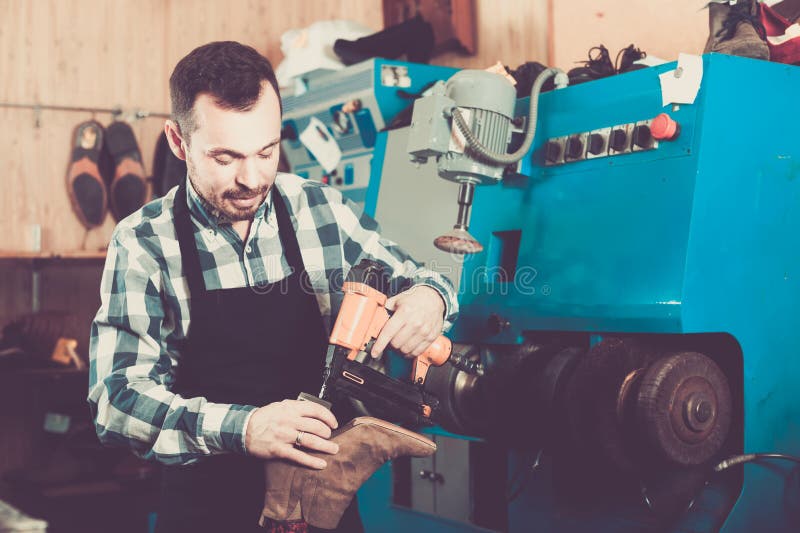 Worker Working at Restoring Boot in Repair Workplace Stock Photo ...