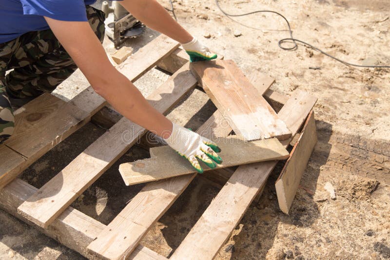 Worker Working with Wooden Planks at Construction Site Stock Photo ...
