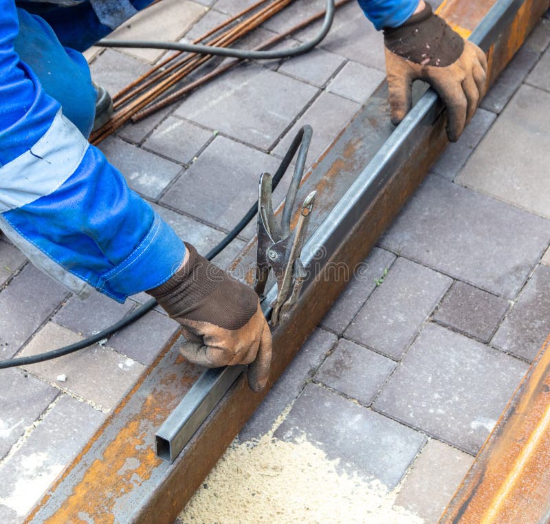A Worker Works with Metal at a Construction Site. Stock Photo - Image ...