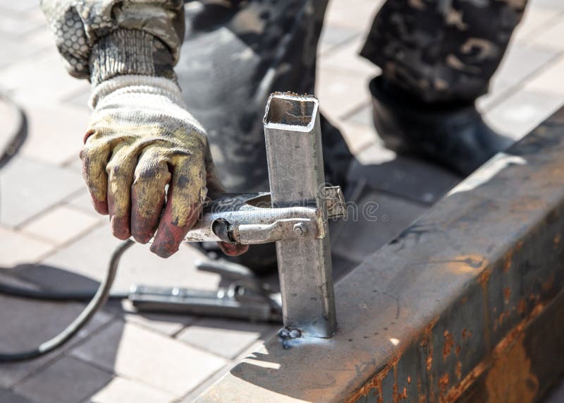 A Worker Works with Metal at a Construction Site. Stock Image - Image ...