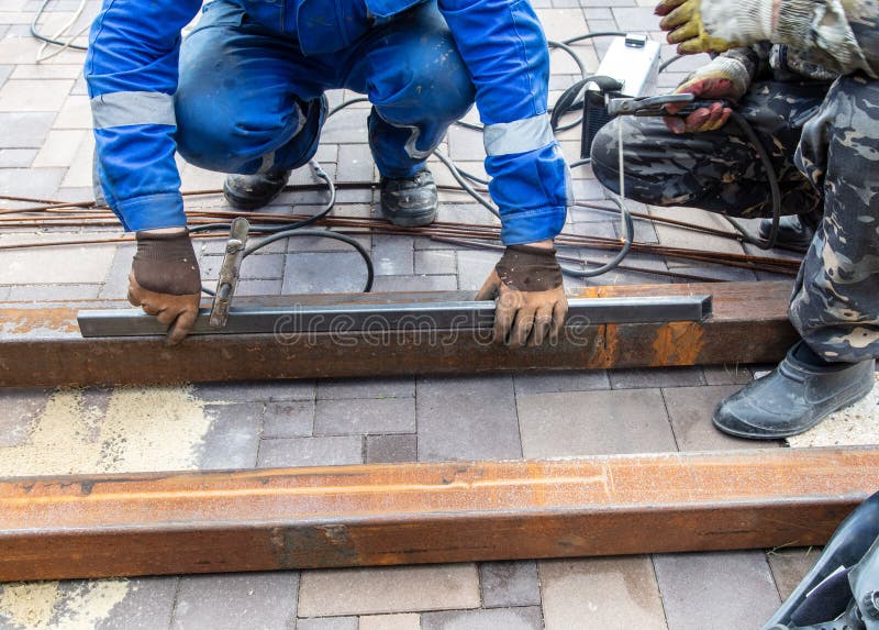 A Worker Works with Metal Welding at a Construction Site. Stock Image ...