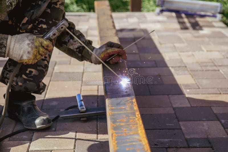 A Worker Works with Metal Welding at a Construction Site. Stock Image ...
