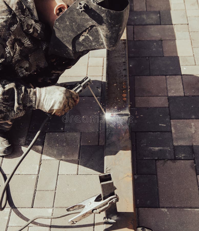 A Worker Works with Metal Welding at a Construction Site. Stock Image ...