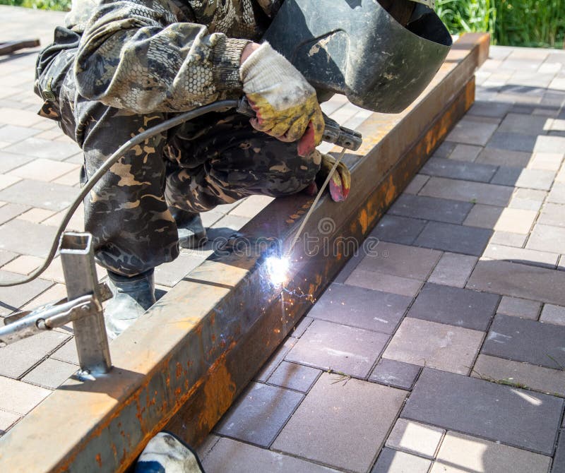 A Worker Works with Metal Welding at a Construction Site. Stock Image ...