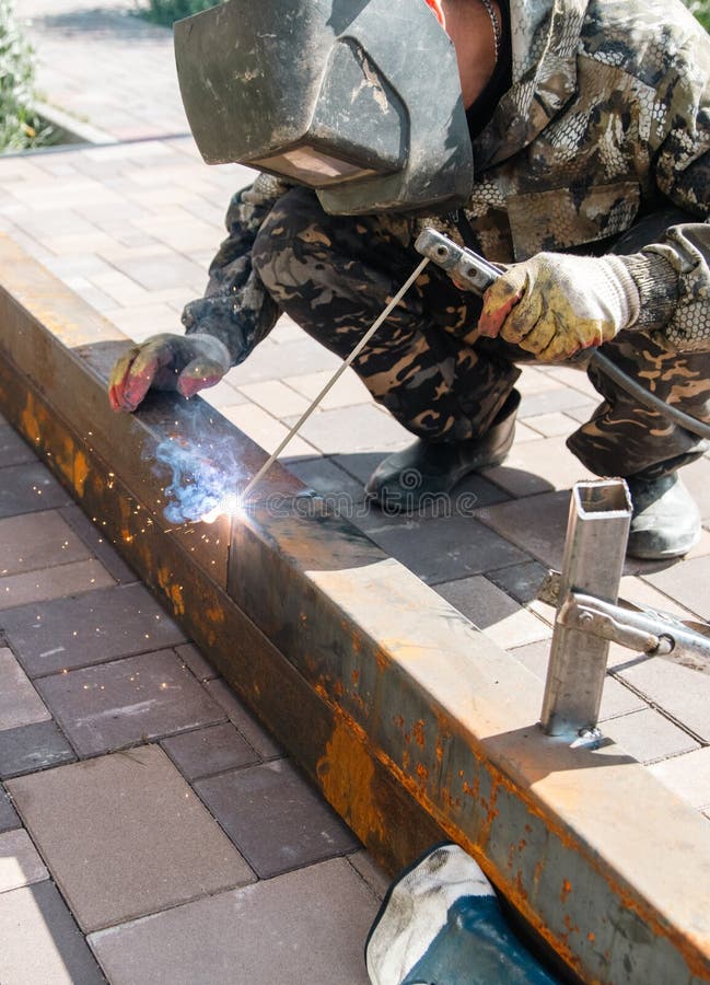 A Worker Works with Metal Welding at a Construction Site. Stock Photo ...