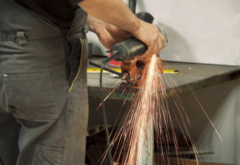 Worker in a Workshop Grinder Processes Metal, from Which Hot Bright ...