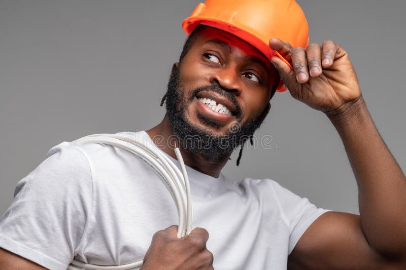 Worker with a Wrapped Cable Over the Shoulder Looking Away Stock Image ...