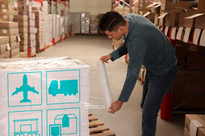 Worker Wrapping Boxes with Shipping Icons in Stretch Film Warehouse ...