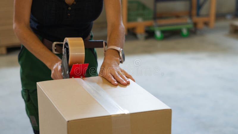 Worker Wrapping a Package with a Bundle Stock Image - Image of closed ...