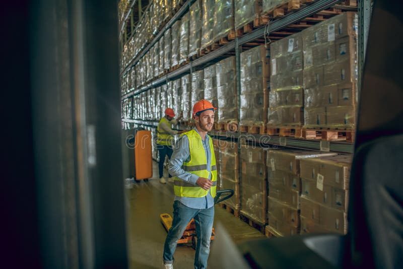Worker in a Yellow Vest and Helmet Looking Busy Stock Photo - Image of ...