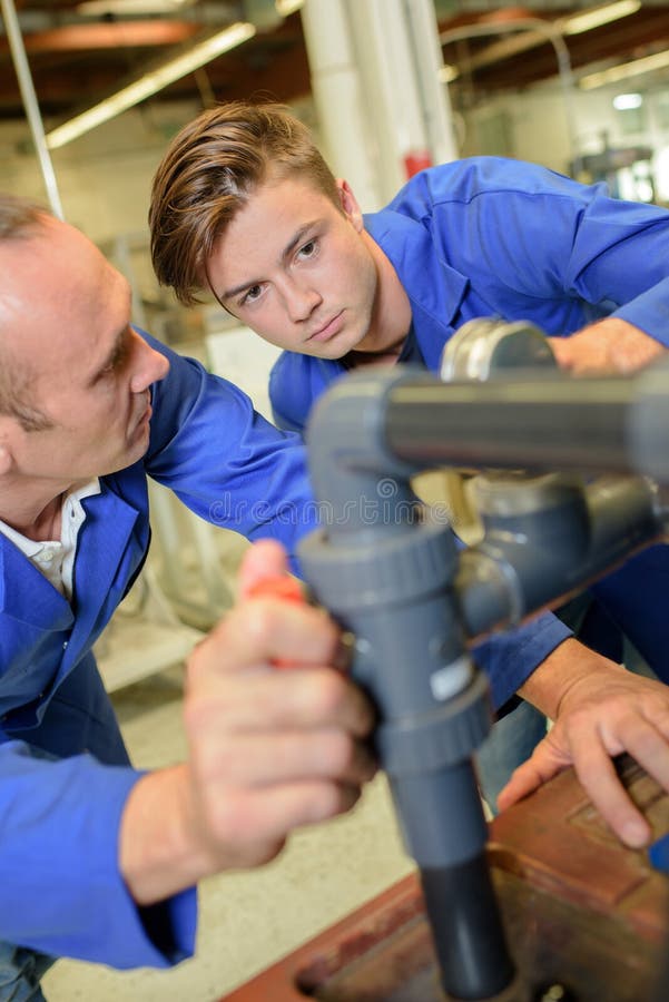 Worker and Young Apprentice Checking Gauge Stock Image - Image of ...