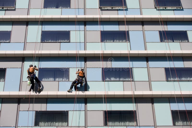 High Rise Window Cleaning Worker Cleans an Office Building Stock Photo ...