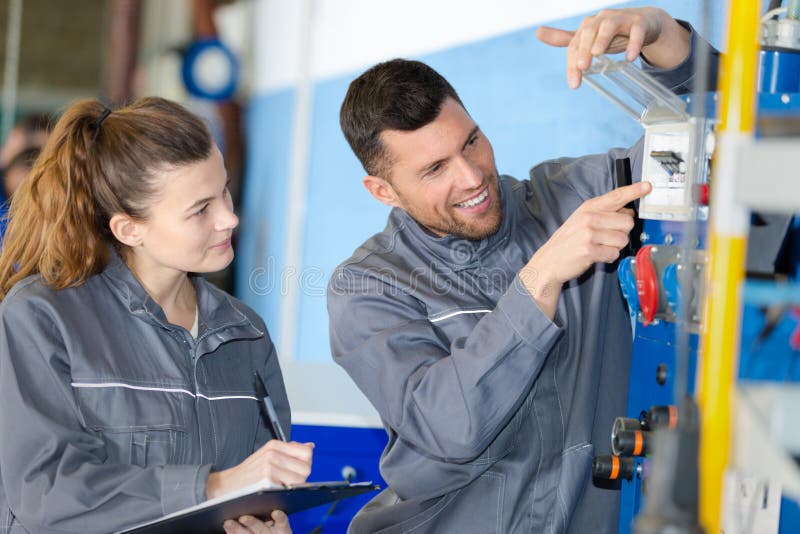 Workers Adjusting Dial on Machine Stock Image - Image of maintenance ...