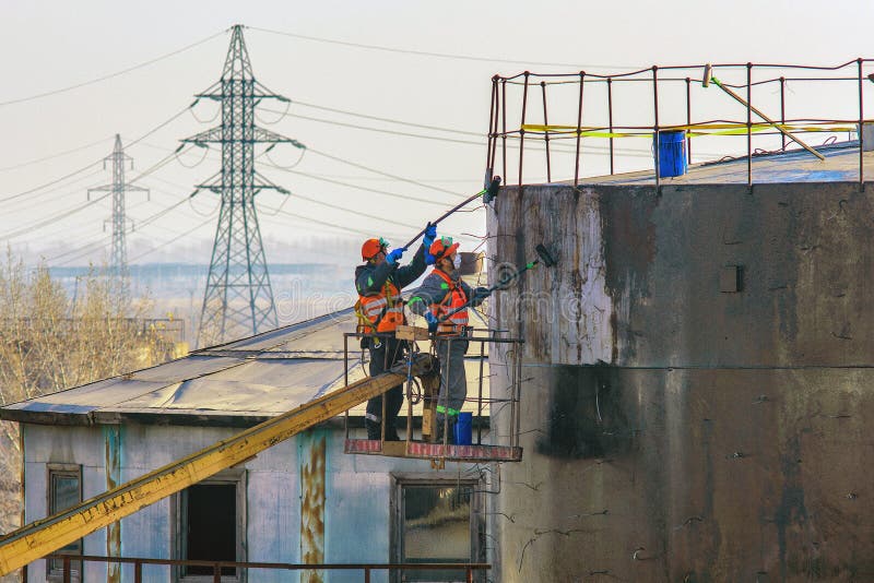 Workers on an Aerial Platform Paint an Industrial Facility Stock Photo ...