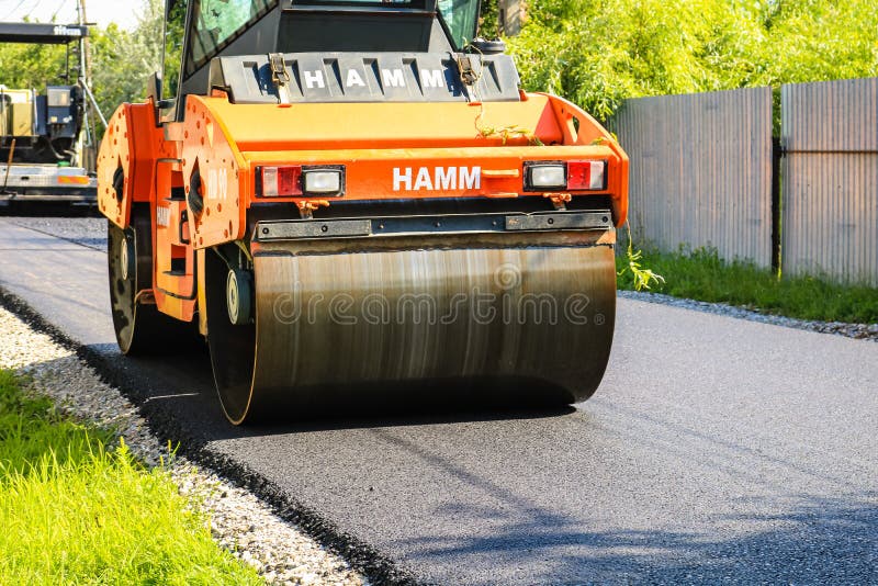 Workers and Asphalting Machines. Construction, Asphalting of New Road ...