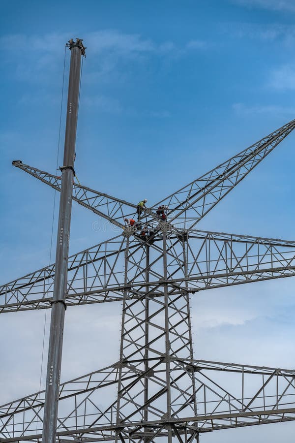 Workers Assembling a Power Pole at High Altitude Editorial Photo ...
