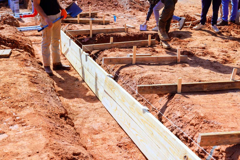Construction Workers Prepare a Foundation at a Building Site during a ...