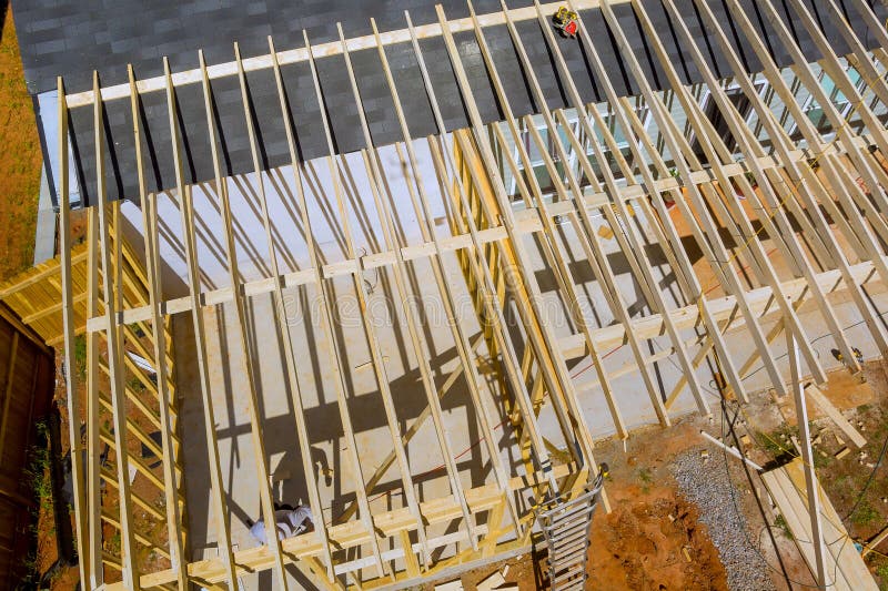 Construction Progress on a New Building with Wooden Framing Under a ...